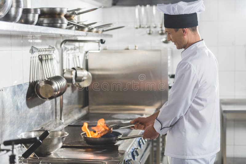 Side View of Handsome Chef Frying Steak with Fire Stock Image - Image ...