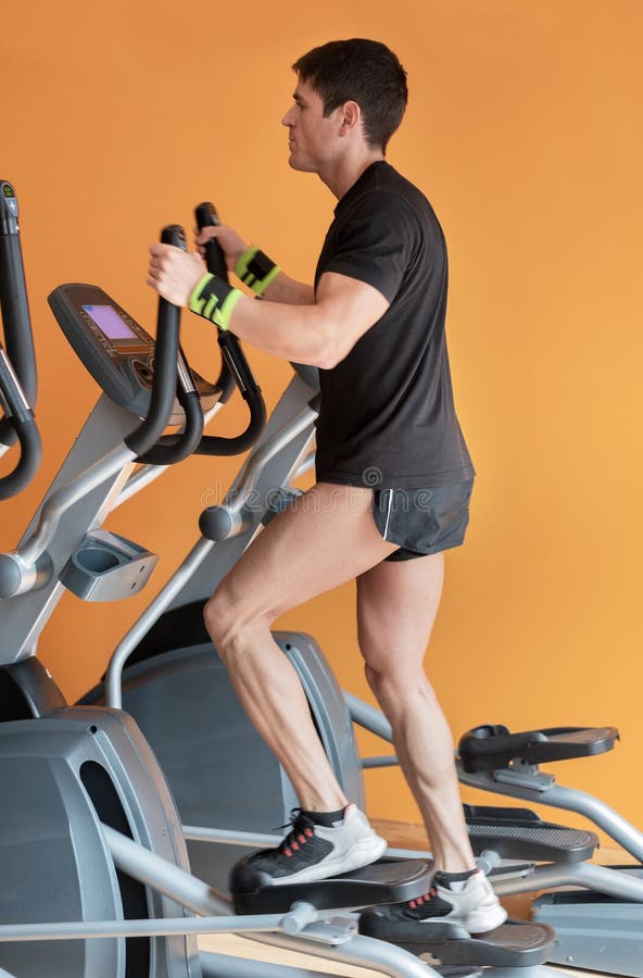 Side View of Handsome Man on Elliptical Trainer. Stock Image - Image of ...