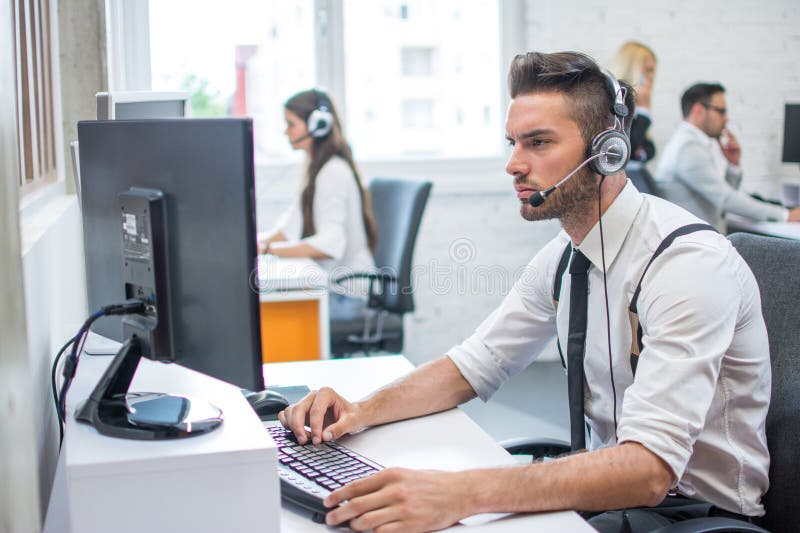 Side View of Handsome Man Technical Support Operator Working on ...