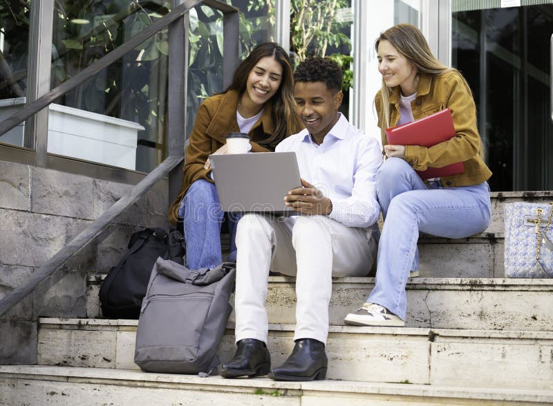 Side View of Happy Diverse Students Using Laptop and Collaborating on ...