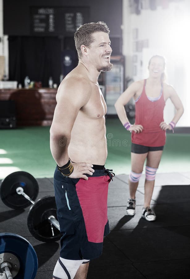 Happy Male Trainer Standing in Gym Stock Photo - Image of bodybuilder ...