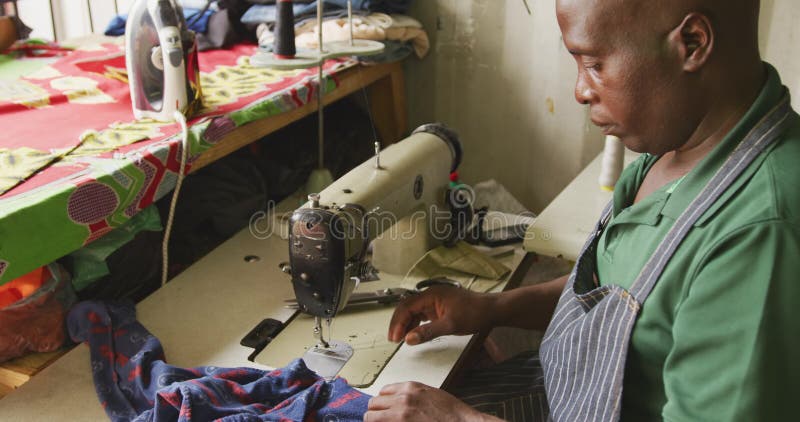 African man sewing tissue stock footage. Video of expertise - 171077802