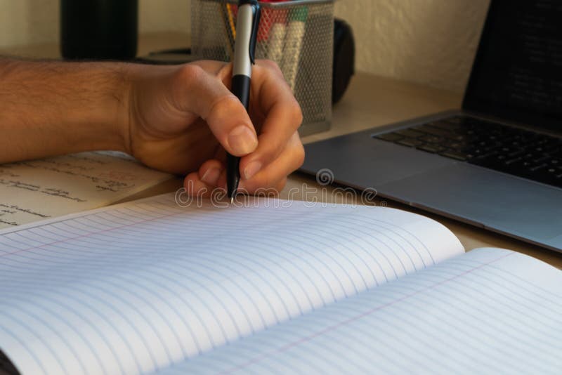 Side View of High School or College Student Studying and Writing in a ...