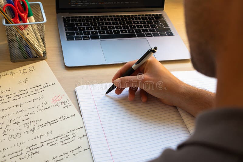 Side View of High School or College Student Studying and Writing in a ...