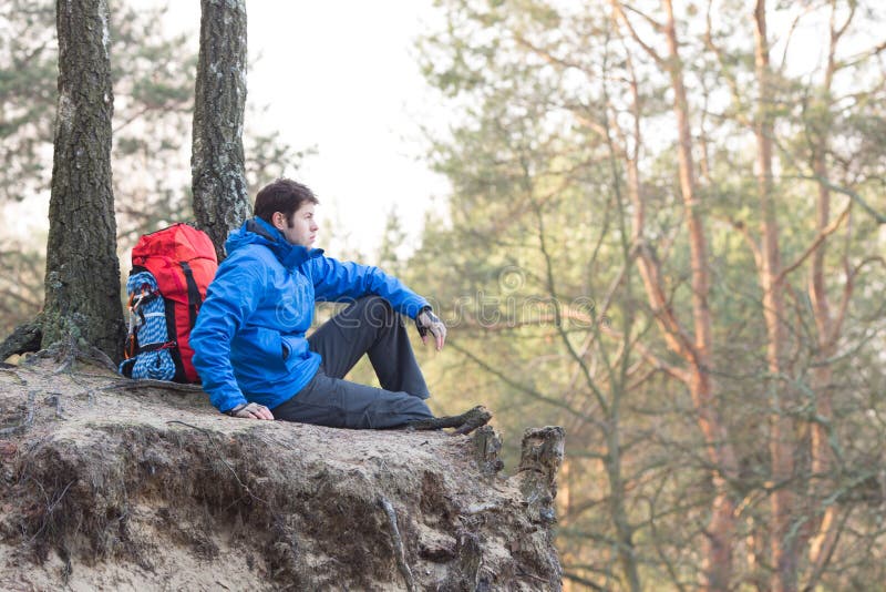 Side View of Hiker Sitting on Edge of Cliff in Forest Stock Image ...