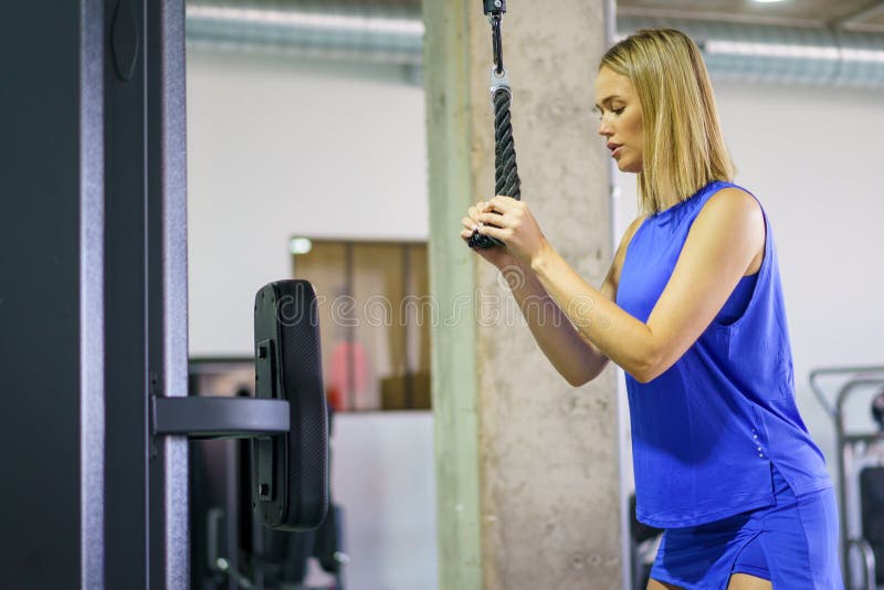 Beautiful Woman Exercising on a Lat Pulldown Machine Stock Image ...