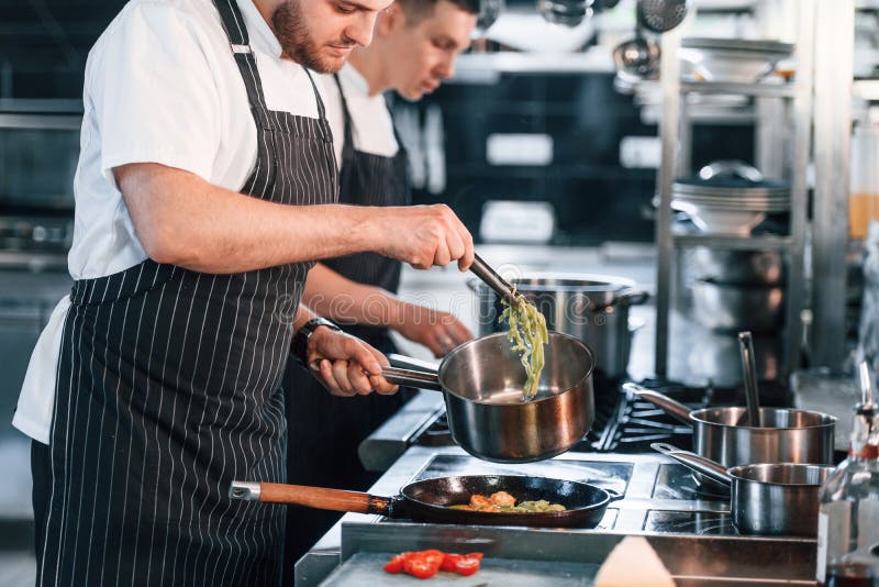 Side View. Kitchen Workers is Together Preparing the Food Stock Photo ...
