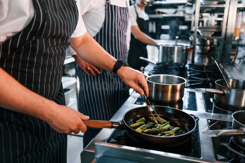Side View. Kitchen Workers is Together Preparing the Food Stock Photo ...