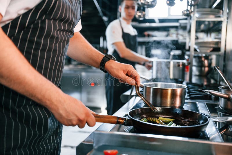 Side View. Kitchen Workers is Together Preparing the Food Stock Photo ...