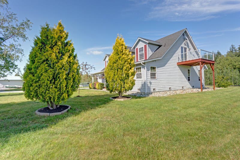 Side View of a Light Blue Home with Green Lawn Around it. Stock Photo ...