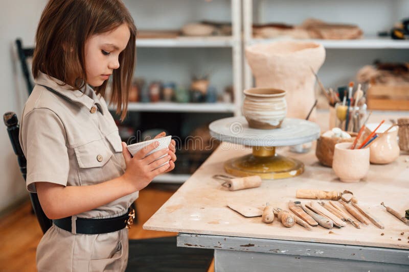 Side View. Little Girl is Indoors with Ceramic Pot in Hands Stock Image ...