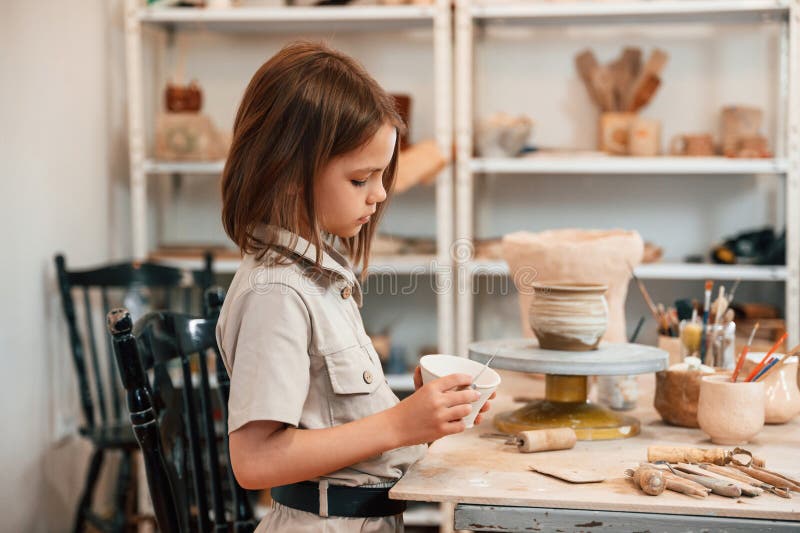 Side View. Little Girl is Indoors with Ceramic Pot in Hands Stock Image ...