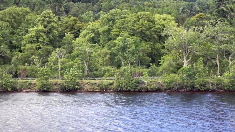 Side View of Loch Ness during Navigation on a Boat. Some Unrecognizable ...