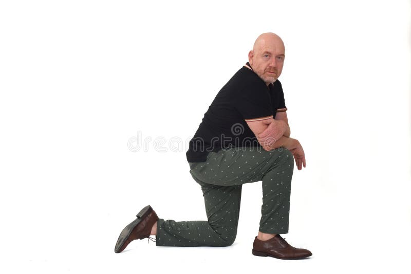 Side View and Looking at Camera of Serious Man Leaning on One Knee ...