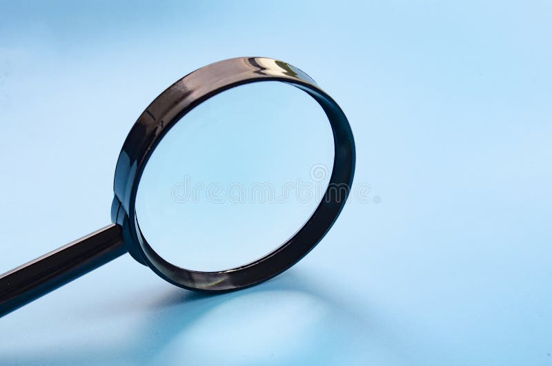 Side View of Magnifying Glass on Blue Cover Background with ...