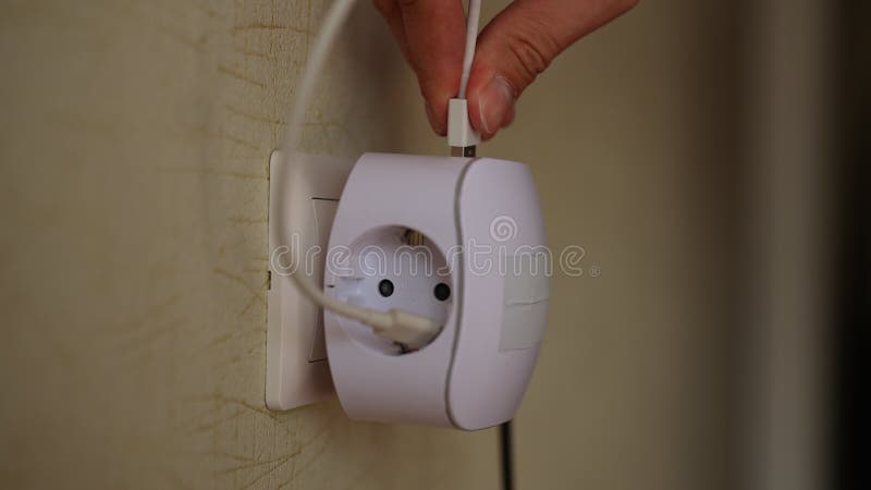 Male Hand Carefully Disconnecting Black Cable from White Power Adapter ...