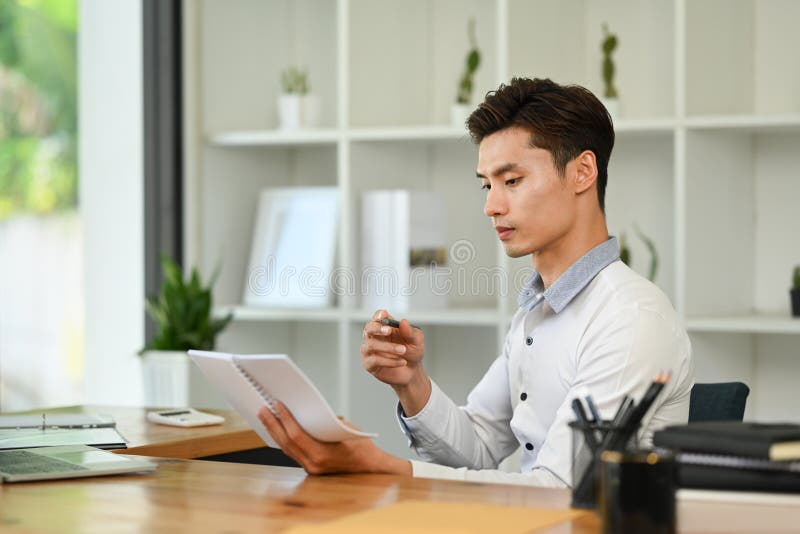 Side View of Male Manager Analyzing Weekly Schedule in His Notebook ...