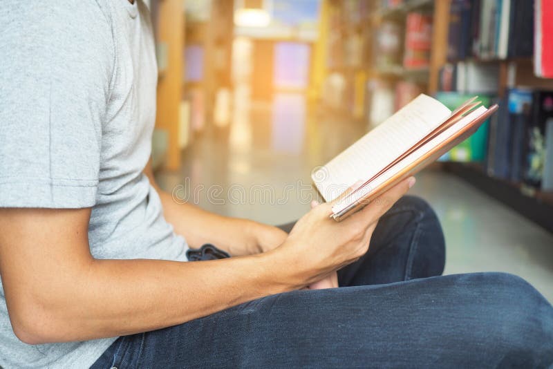 Side View of Male Student Reading Books in Library Stock Photo - Image ...