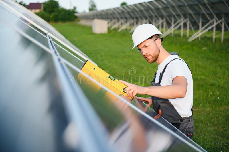 Side View of Male Worker Installing Solar Modules and Support ...