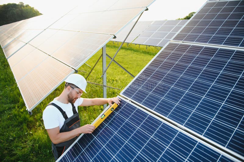 Side View of Male Worker Installing Solar Modules and Support ...