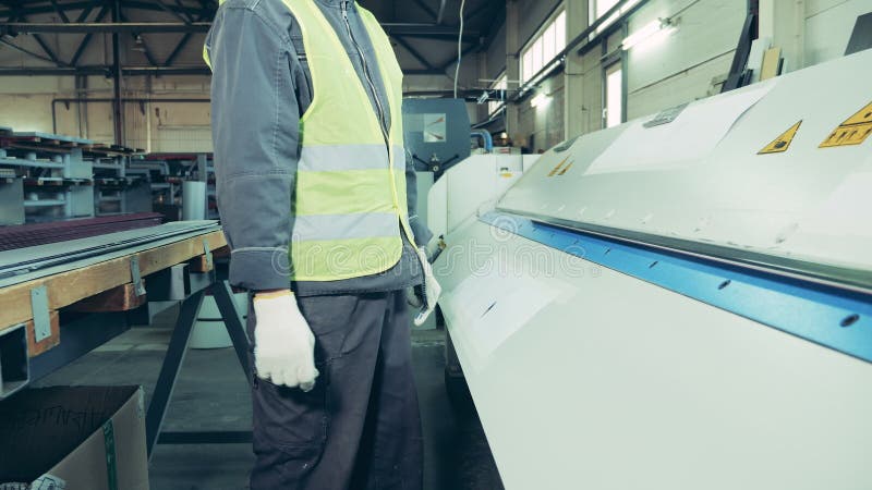 Side View of a Male Worker Loading Metal into the Bending Machine Stock ...