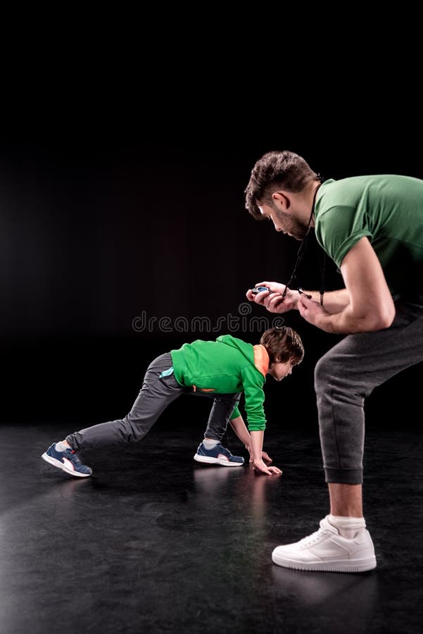 Side View of Man Controlling Time while Boy Training Stock Image ...