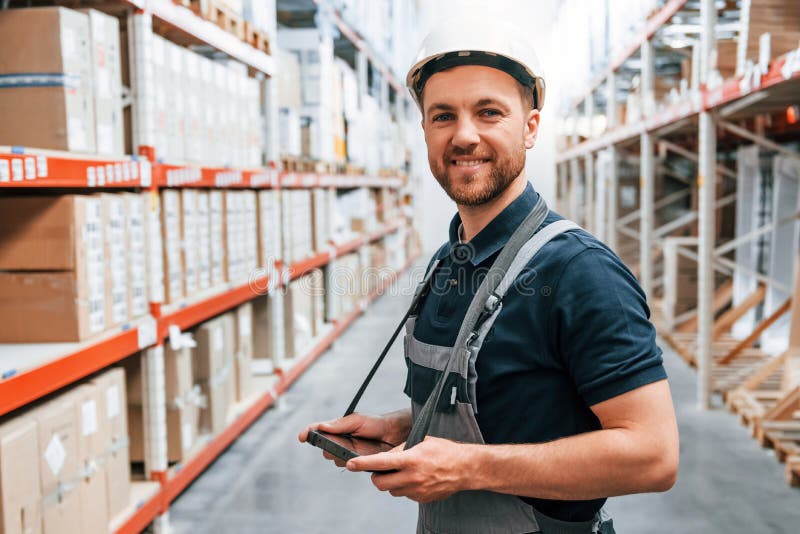 Side View of Man that Holding Tablet. Employee in Uniform is Working in ...