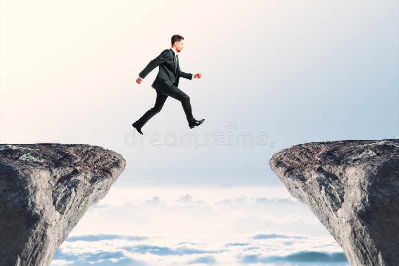 Side View of Man Jumping on Cliff Edge on Bright Blue Sky Background ...