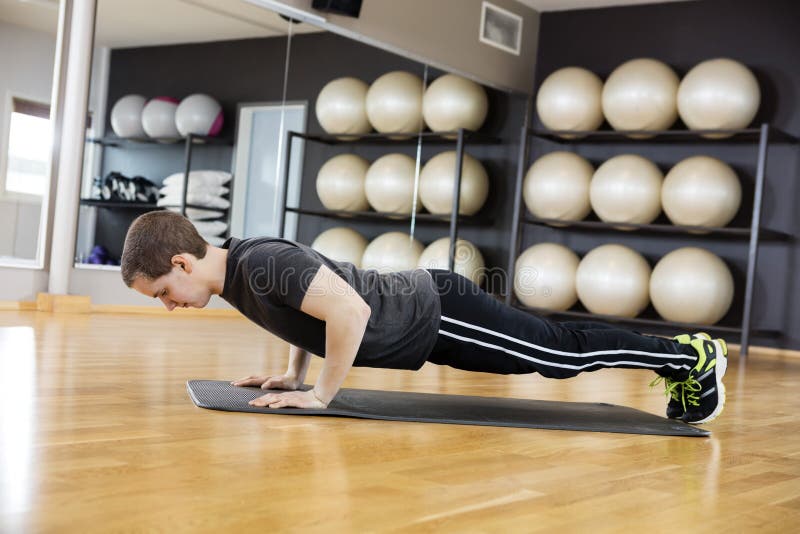 Side View of Man Performing Pushups in Gym Stock Image - Image of ...