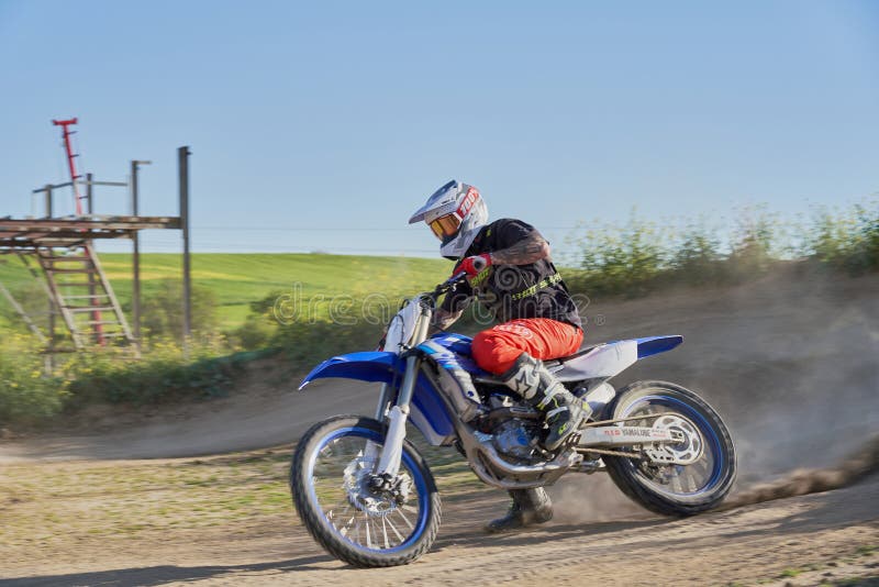 Side View of Man Performing Stunt with Motorcycle on Motocross Track ...