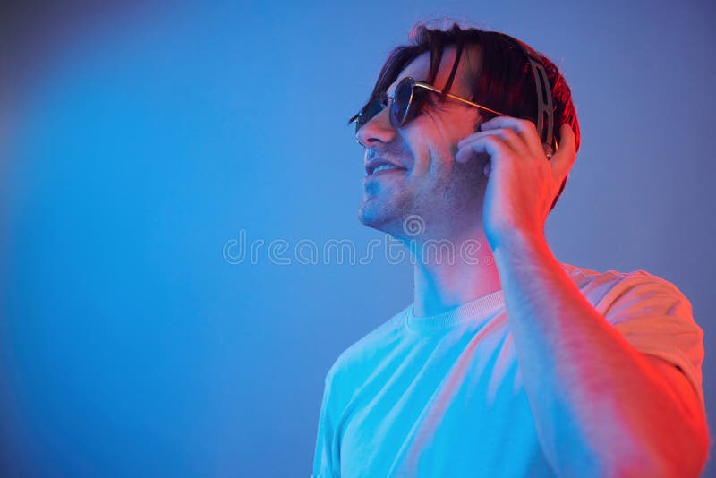 Side View. Man Standing in the Studio with Neon Light Stock Image ...