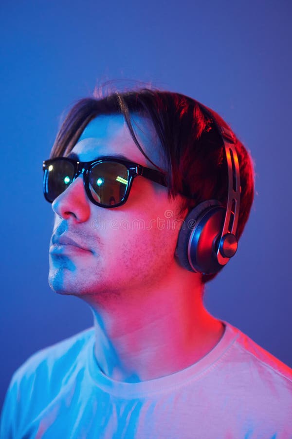 Side View. Man Standing in the Studio with Neon Light Stock Image ...