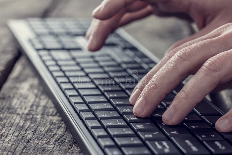 Side View of a Man Typing on a Wireless Computer Keyboard Stock Image ...