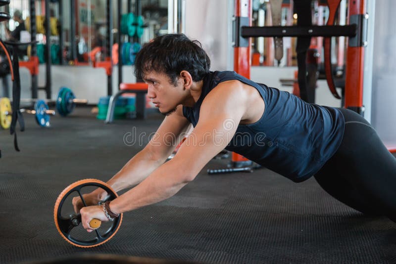 Side View Man Using Abdominal Roller Stock Photo - Image of athlete ...