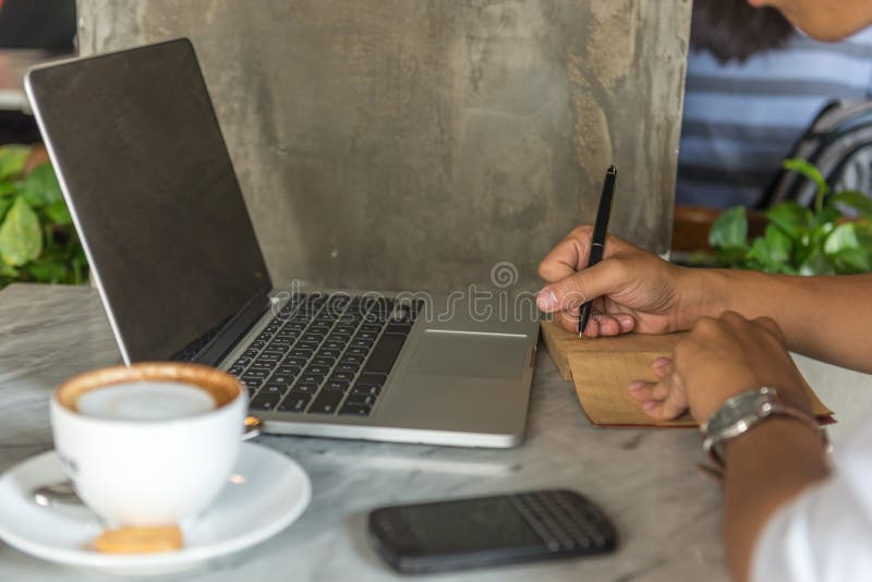 Side View of Man Using Laptop and Writing Notes Stock Photo - Image of ...