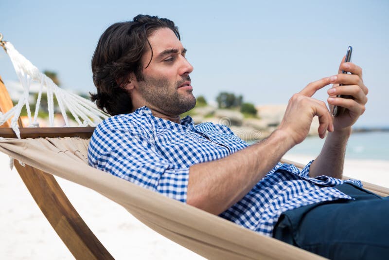Side View of Man Using Mobile while Relaxing in Hammock Stock Image ...