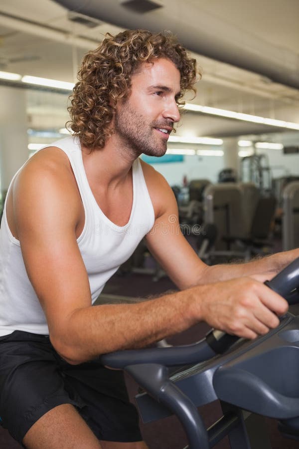 Side View of Man Working Out on Exercise Bike at Gym Stock Image ...
