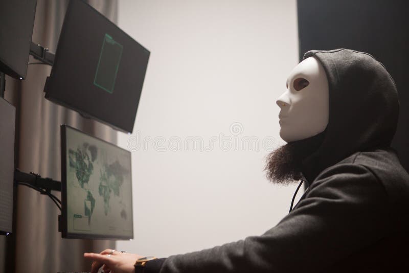 Side View of Masked Hacker Writing a Dangerous Malware Stock Image ...