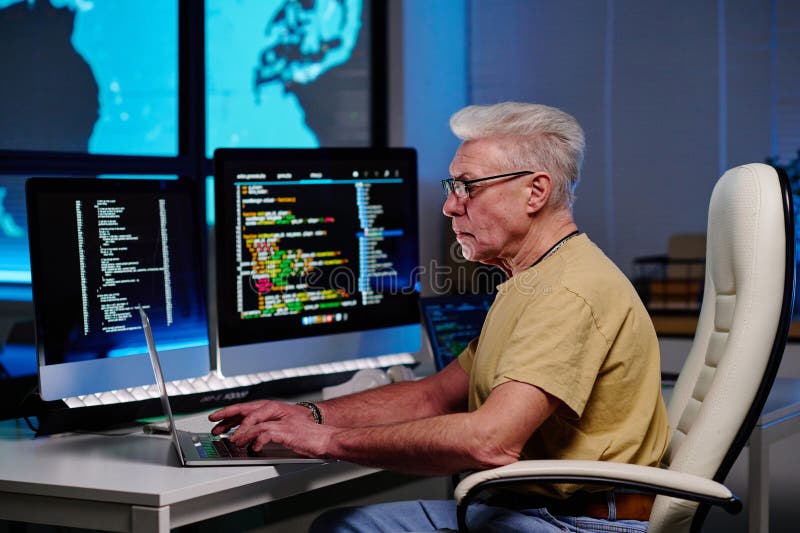 Side View of Mature Male it Manager Looking at Laptop Screen and Typing ...