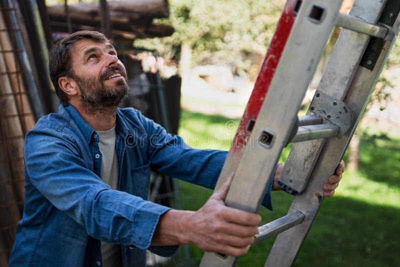Side View of Mature Man Climbing Up the Ladder. Stock Photo - Image of ...