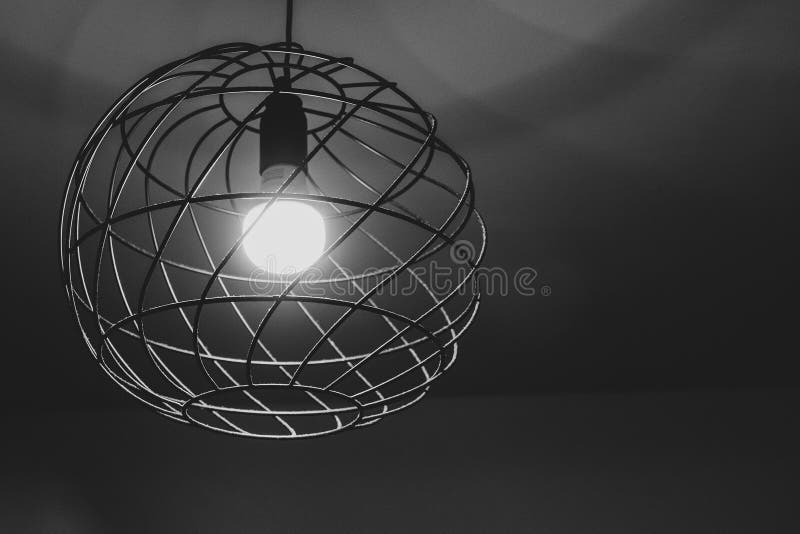 Side View of a Metal Ring Shape Lamp Shade with Glowing Light Bulb in ...