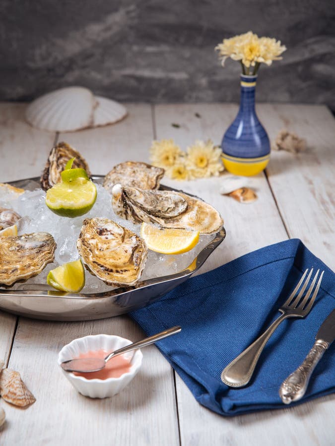 Side View on a Metallic Bowl with Fresh Appetizing Oysters with Ice and ...