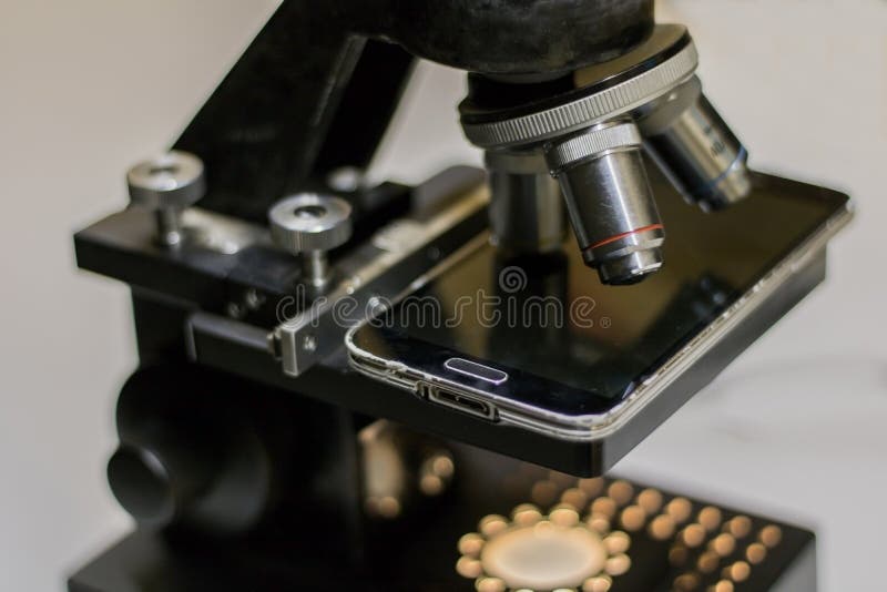 Side View of a Microscope that is Analyzing a Mobile Phone. Stock Image ...