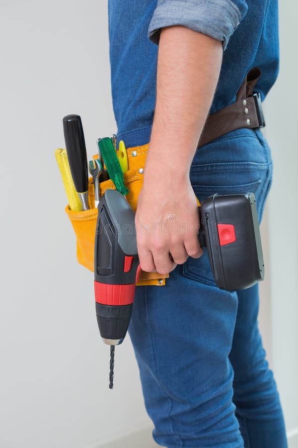 Side View Mid Section of a Handyman with Drill and Toolbelt Stock Image ...