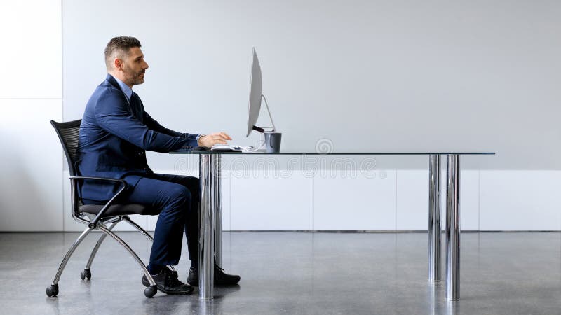 Side View of Middle Aged Male Manager Working on Computer in Office ...