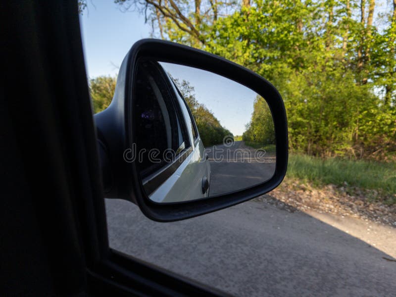 A Side View Mirror of a Car on the Side of a Road Stock Photo - Image ...