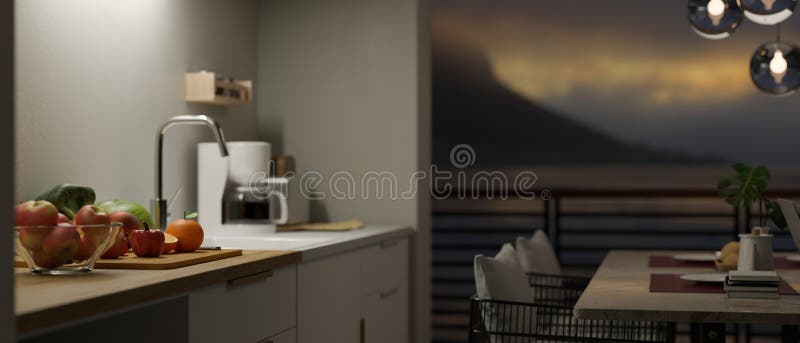 Side View of a Modern Contemporary Kitchen with Dining Table at Night ...