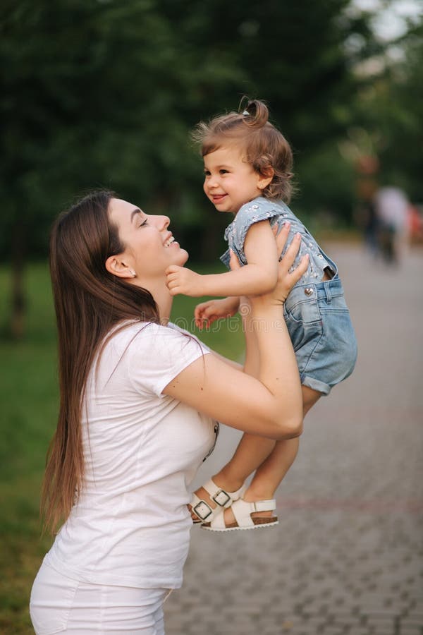 Side View of Mom Hold Little Girl on Hands and Have Fun Stock Image ...