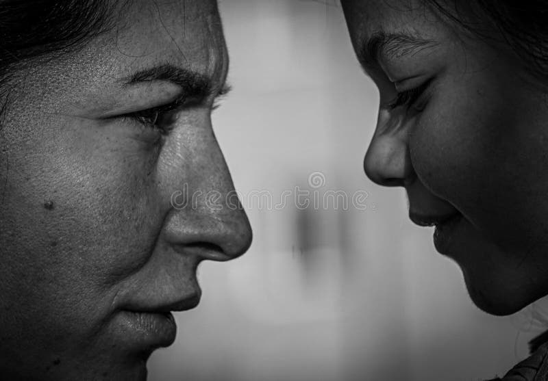 Side View of Mother and Daughter Looking at Each Other Stock Photo ...