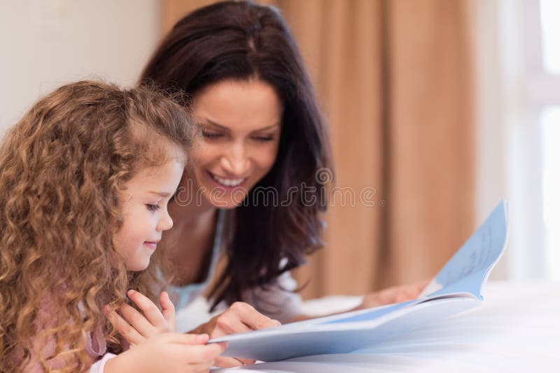 Side View of Mother and Daughter Reading a Book Together Stock Image ...